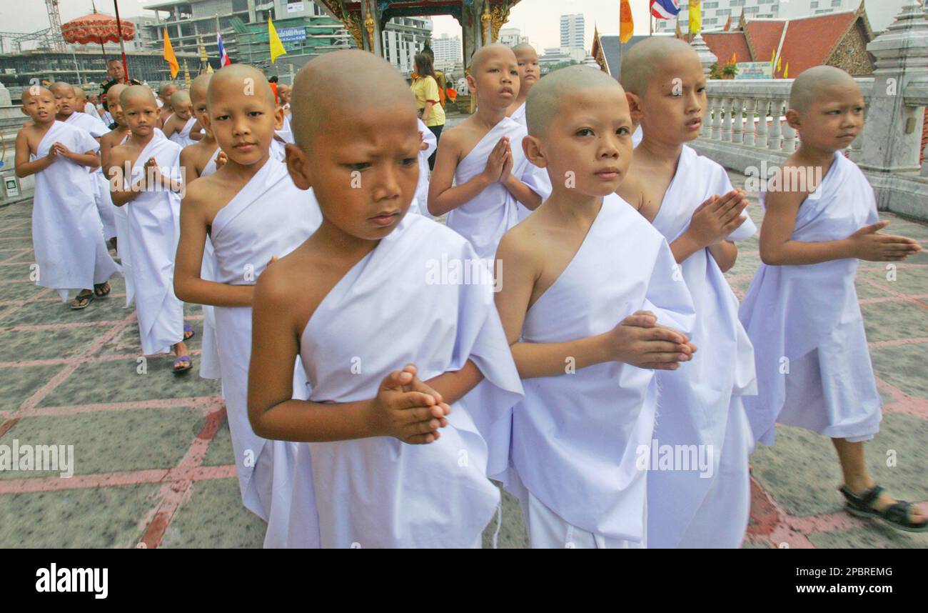 Young Thai boys prepare for prayers during their first day as novice ...