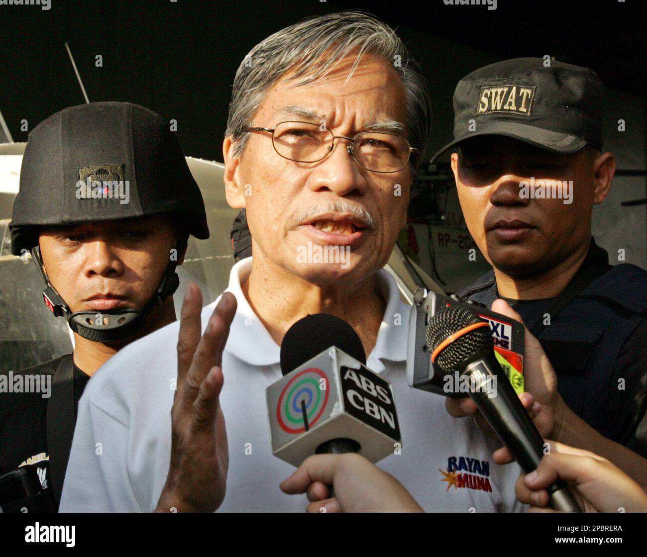 Filipino left-wing Congressman Satur Ocampo is guarded by SWAT members ...