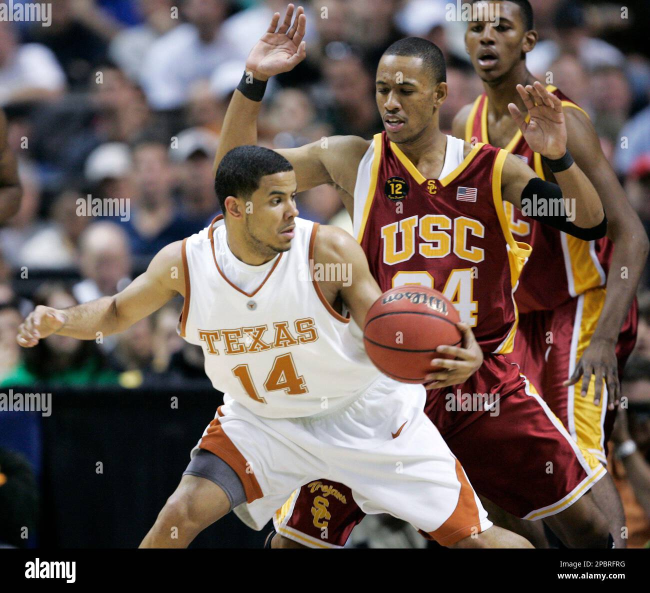 Texas guard D.J. Augustin (14) is guarded by Southern California guard ...