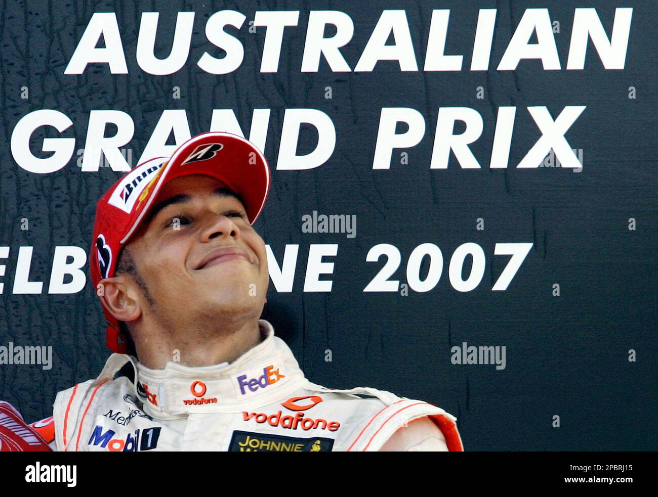 British McLaren Formula One driver Lewis Hamilton reacts on the podium ...