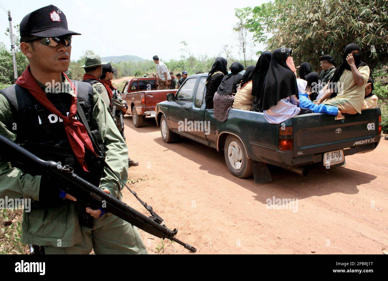 Armed Thai border police officers and soldiers guard at a checkpoint as ...