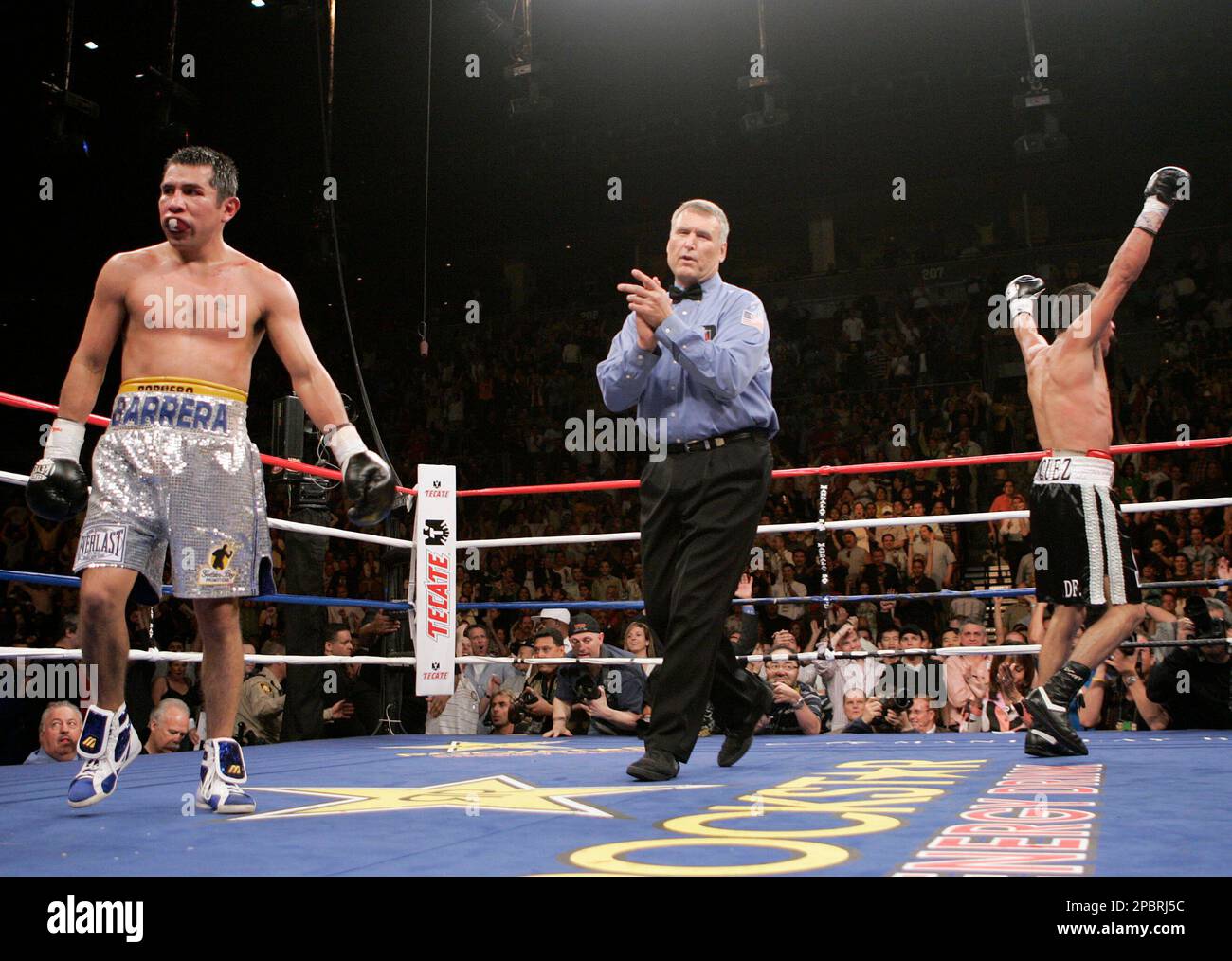 Marco Antonio Barrera, left, of Mexico, walks to his corner as Juan ...