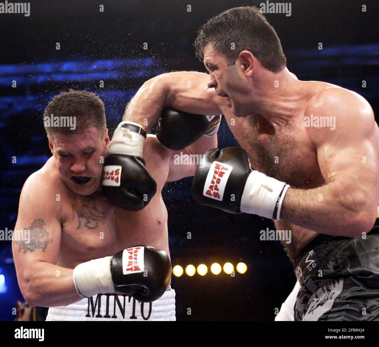 German boxer Luan Krasniqi, right, punches Brian Minto from the USA ...