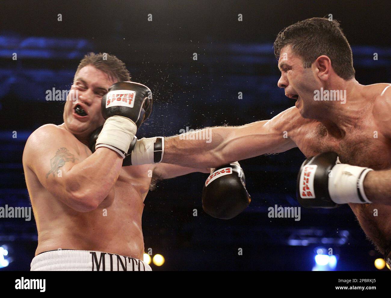 German boxer Luan Krasniqi, right, punches Brian Minto from the USA ...