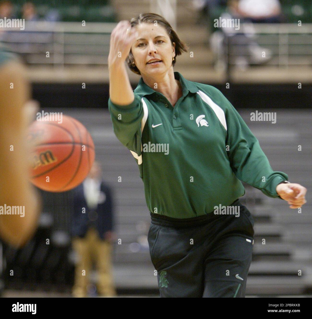 Michigan State coach Joanne P. McCallie throws a pass during practice ...