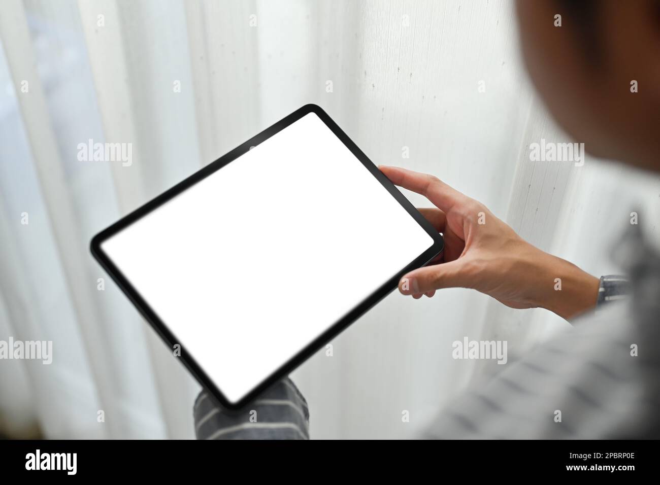 Close up view of man hand holding holding digital tablet while sitting ...