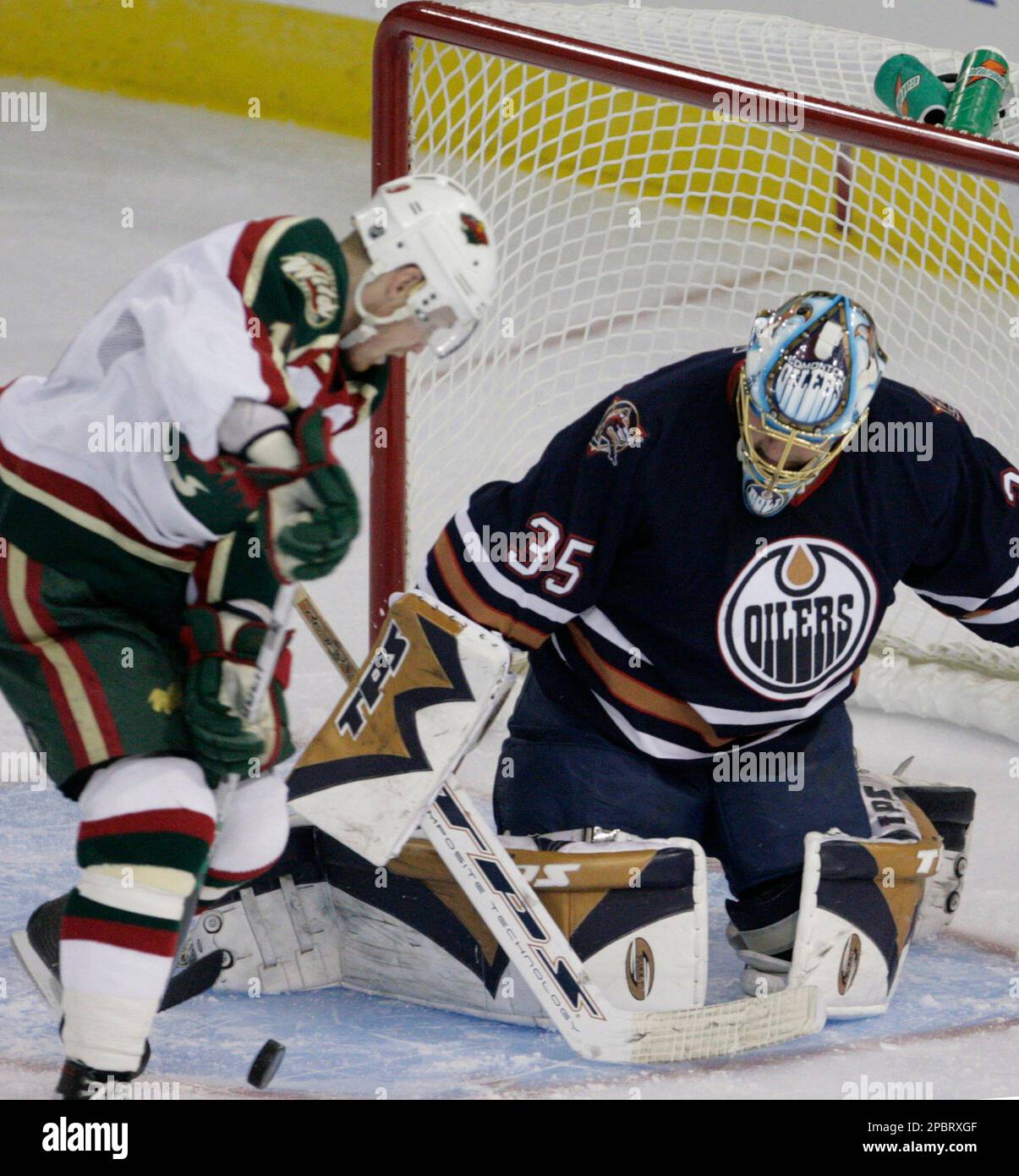 Minnesota Wild's Stephane Veilleux, left, tries to score on Edmonton ...