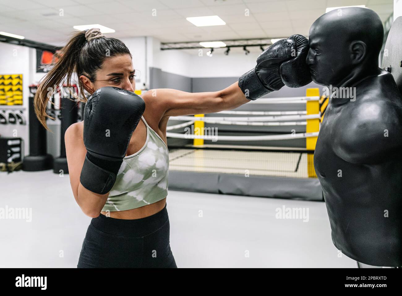 Young strong female athlete punching hi-res stock photography and ...