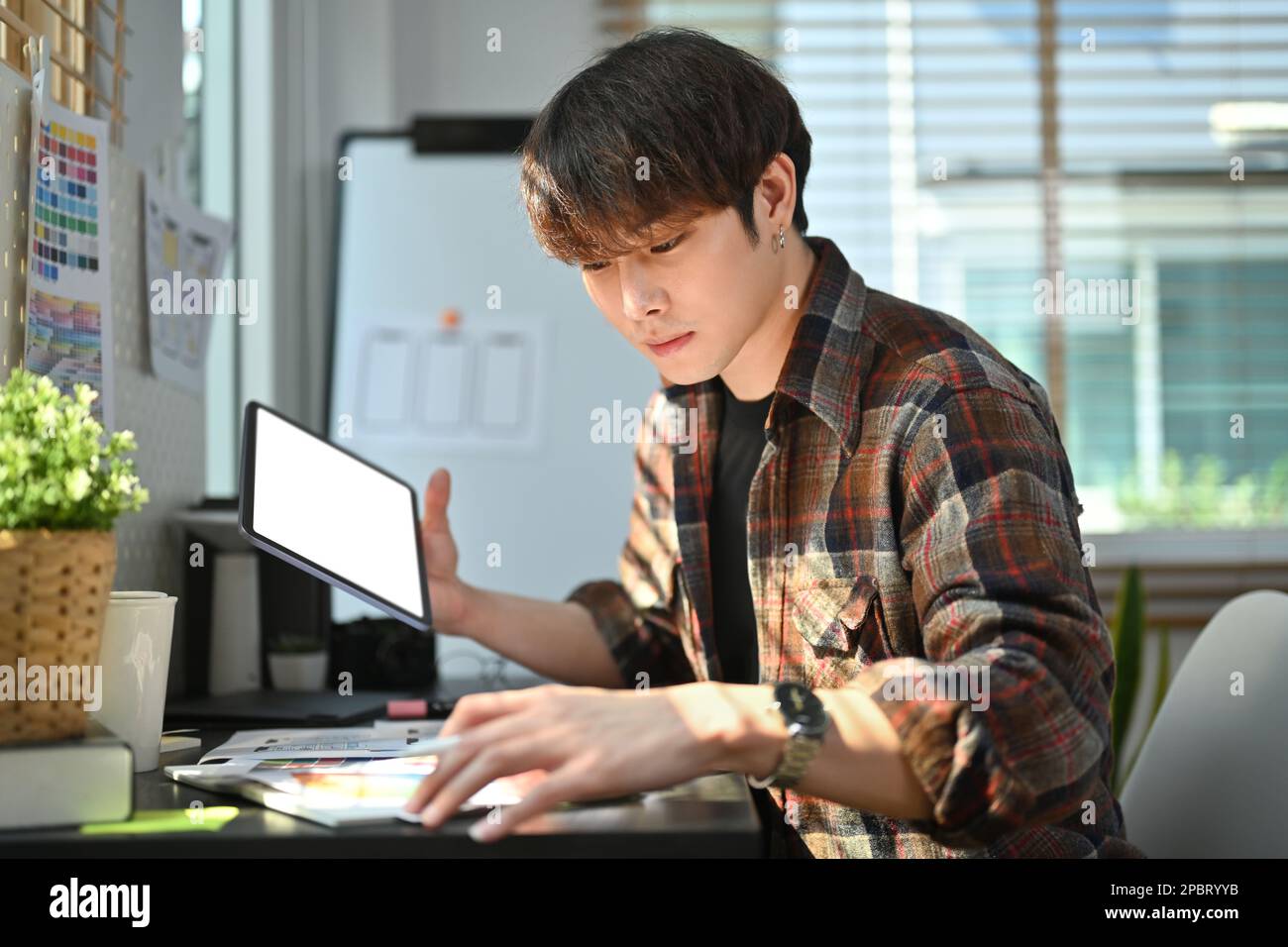 Handsome creative man freelancer working on mobile application software design project together ...