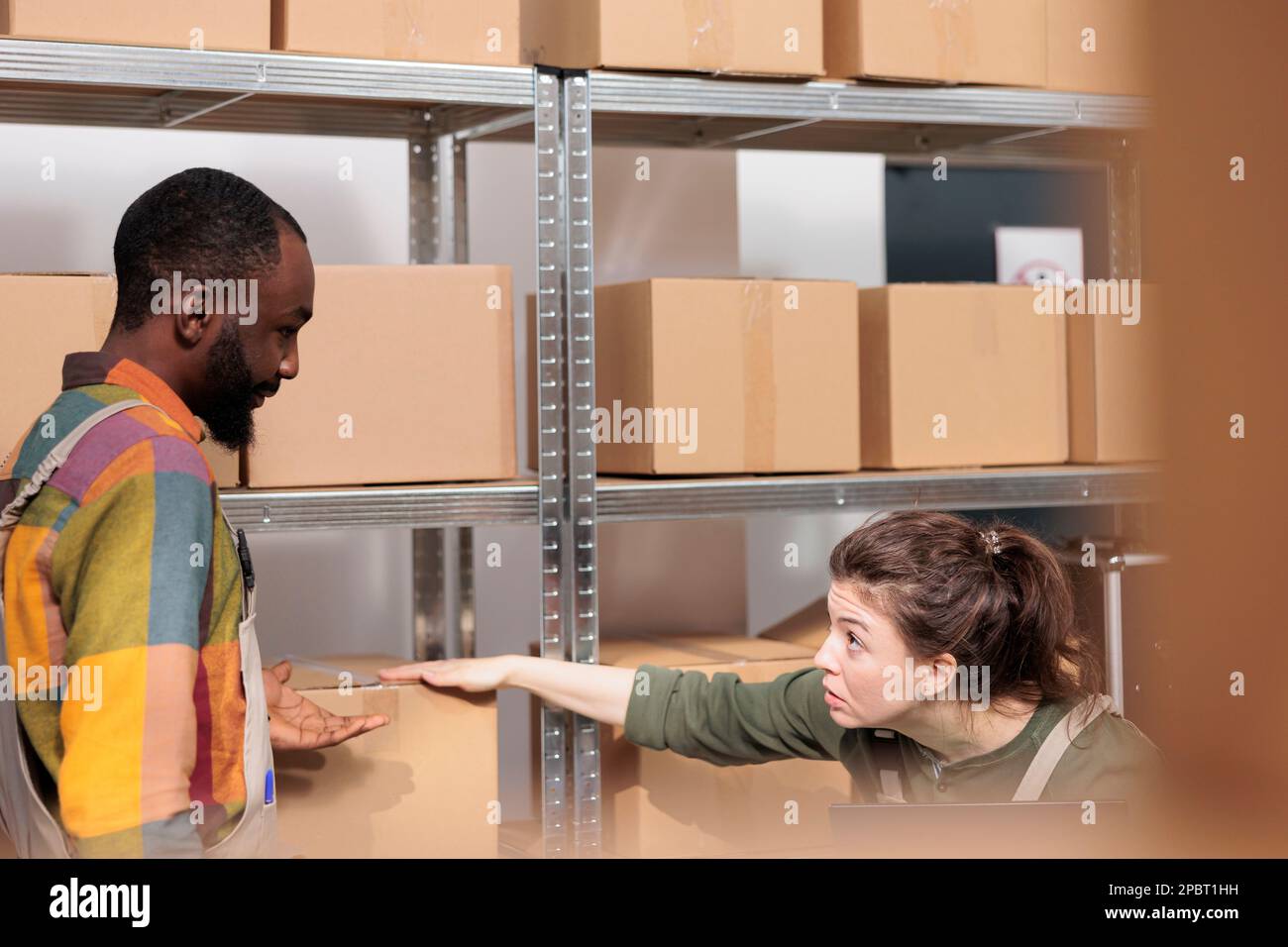 Delivery storehouse employees packing cardboard box and searching ...