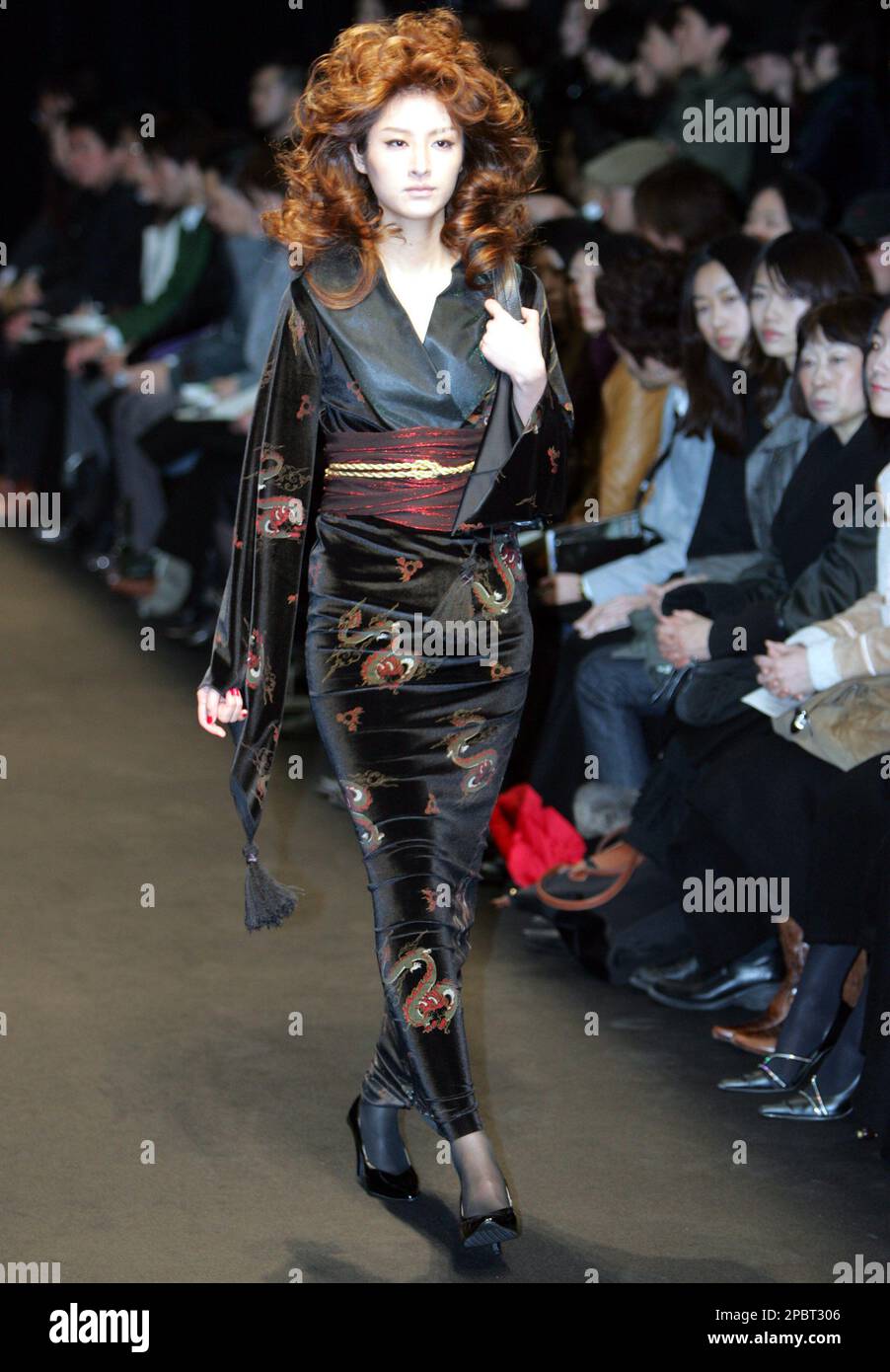 Model displays Japanese designer Emiko Miki's black kimono dress with matching obi sash during ...