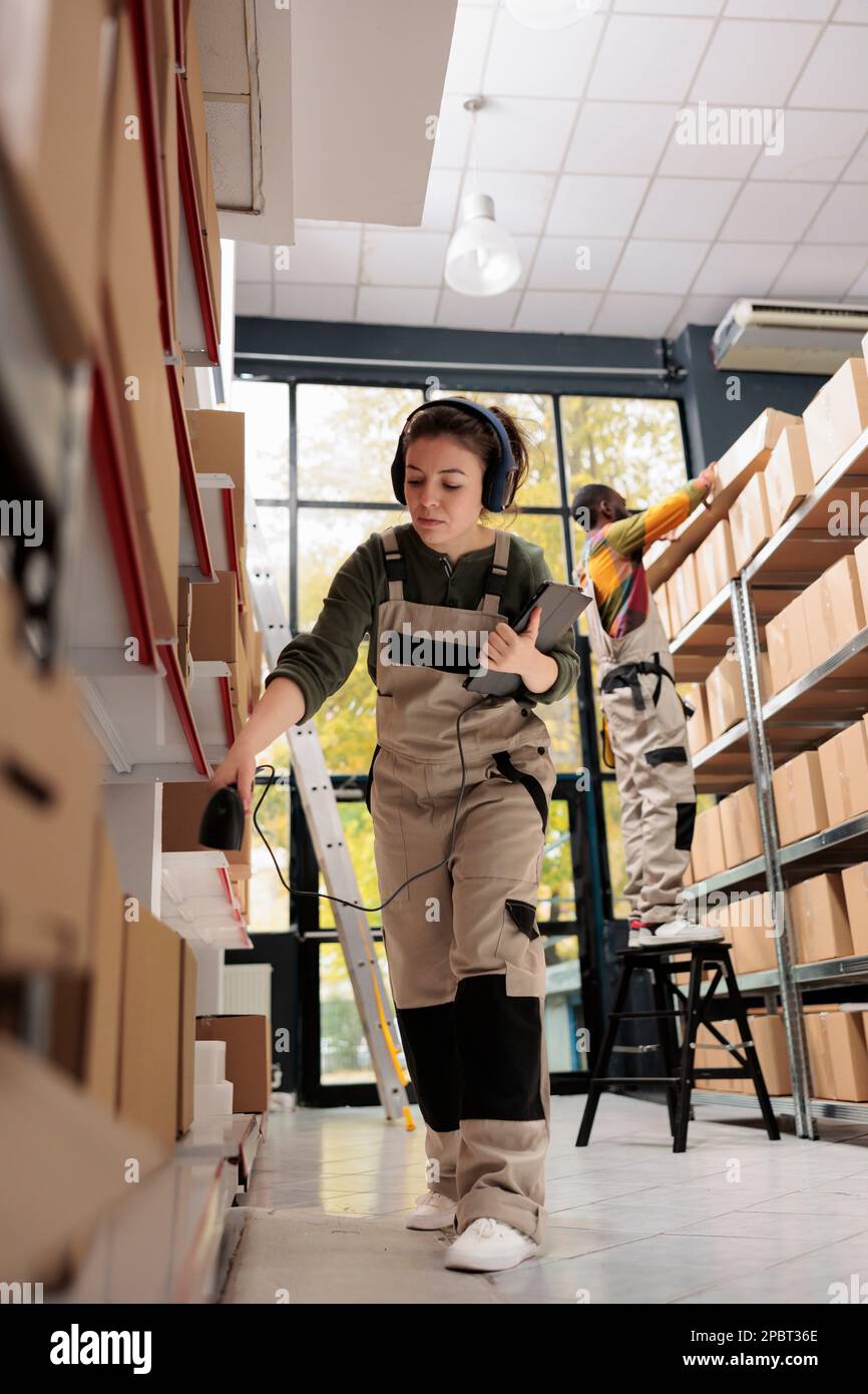 Storehouse Supervisor Scanning Cardboard Boxes Barcode Using Store