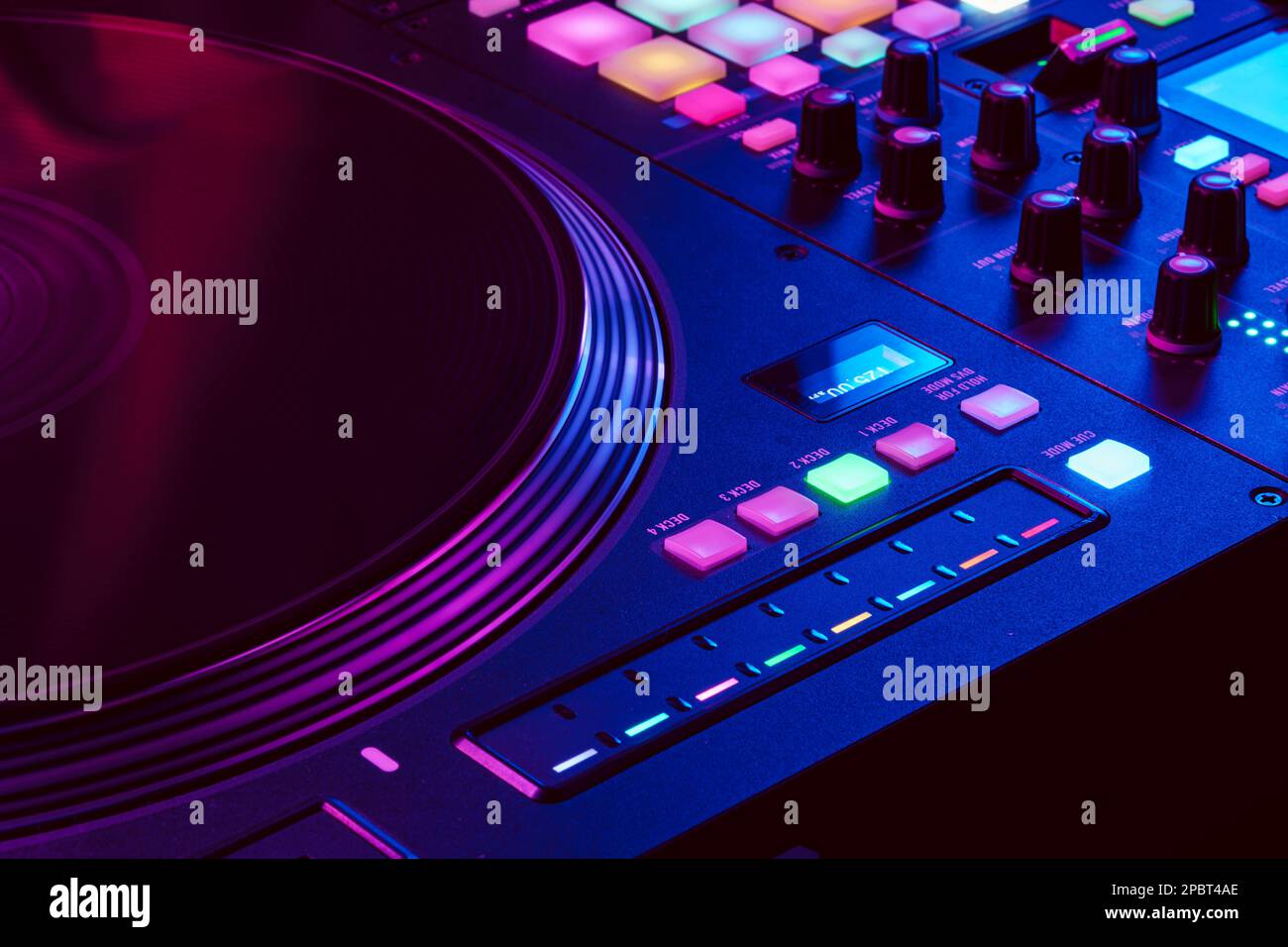 Close up of DJ mixing console in party light Stock Photo - Alamy
