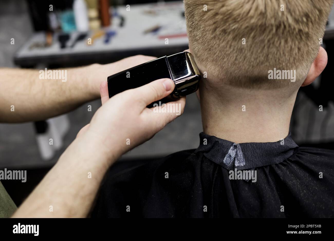 Professional hairdresser doing haircut men's hair. Cutting electric ...