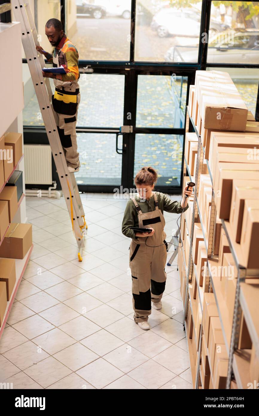 Supervisor scanning carton boxes using store scanner during storehouse ...