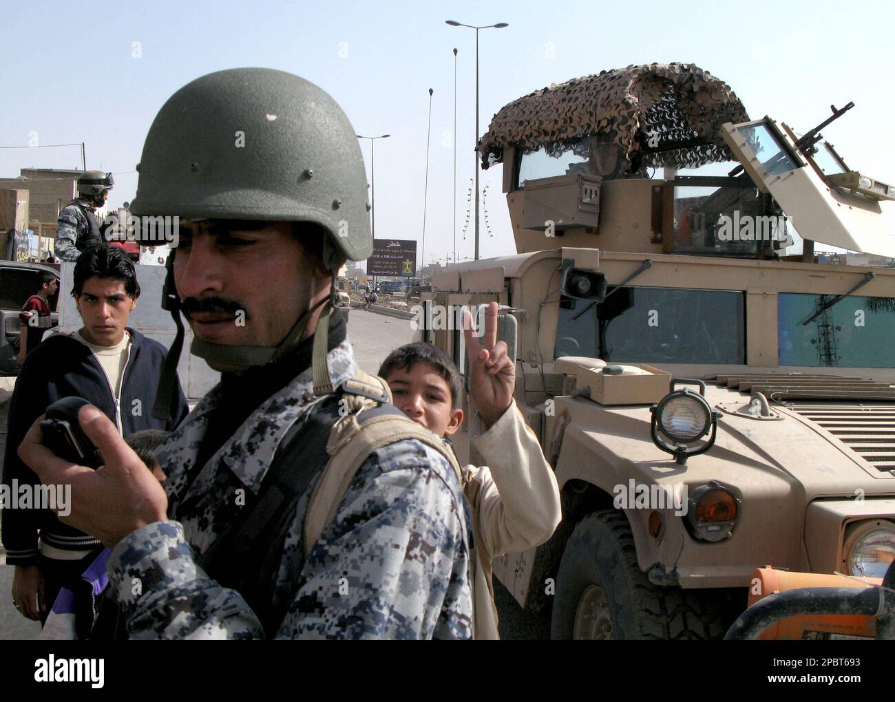 An Iraqi army soldier communicates via radio while on a patrol in ...
