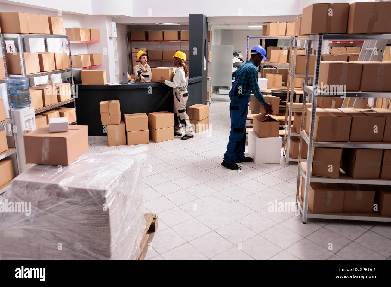 Shipping department employees picking parcels for delivery and putting ...