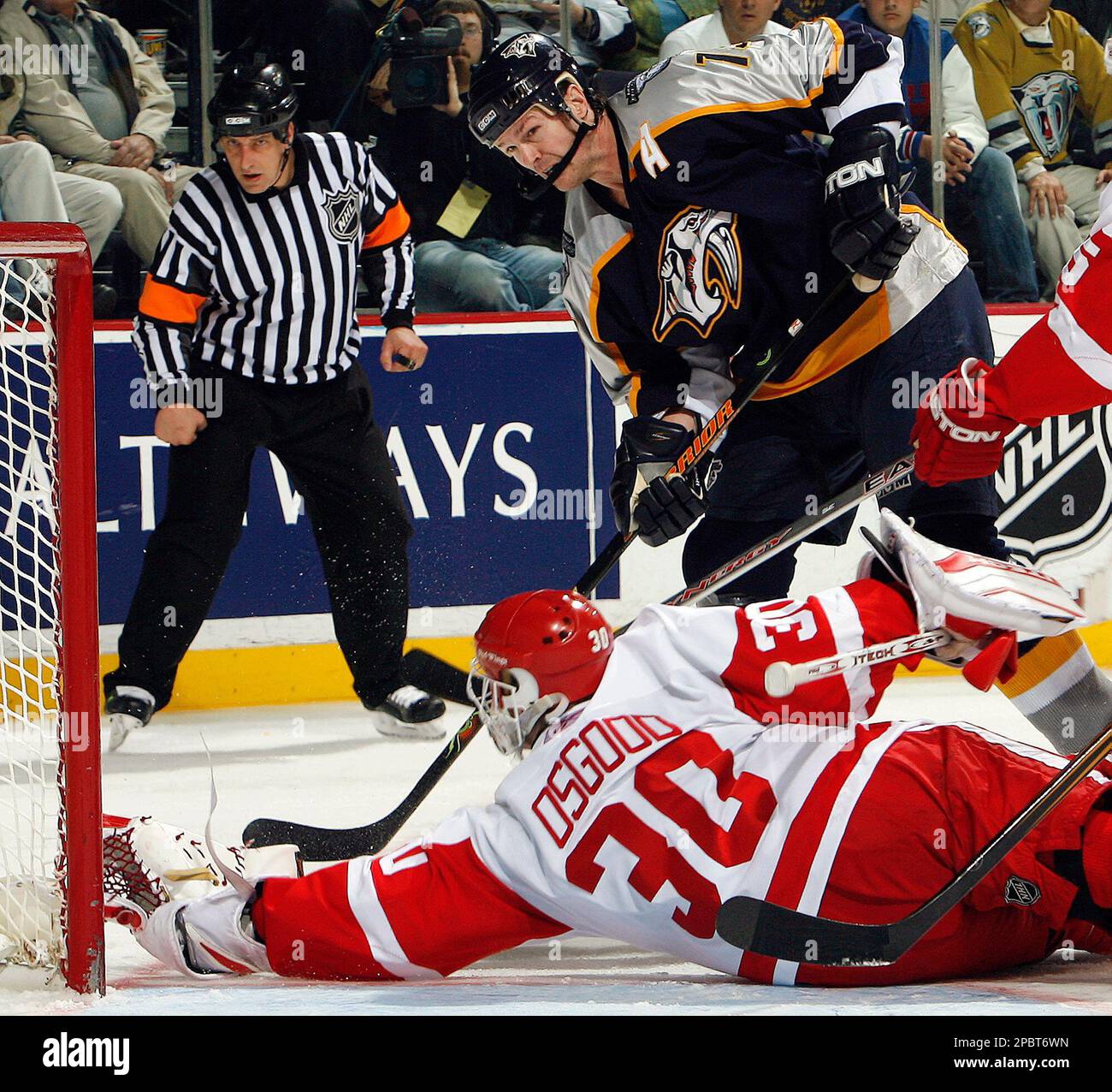 Detroit Red Wings goalie Chris Osgood (30) makes a glove save on a shot ...