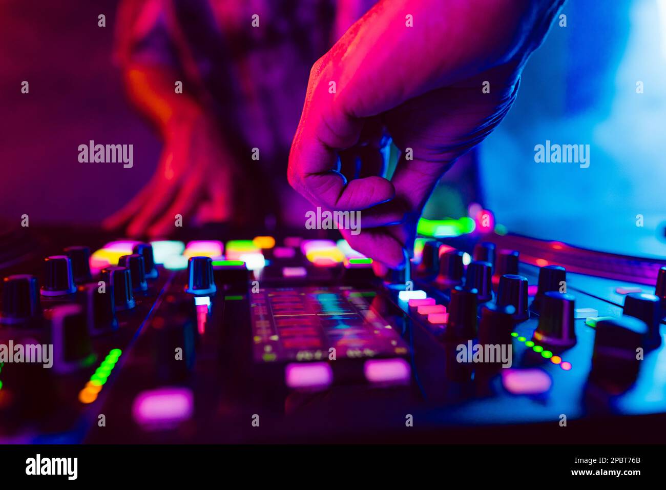 Close up of DJ hands on dj console mixer during concert in the club ...
