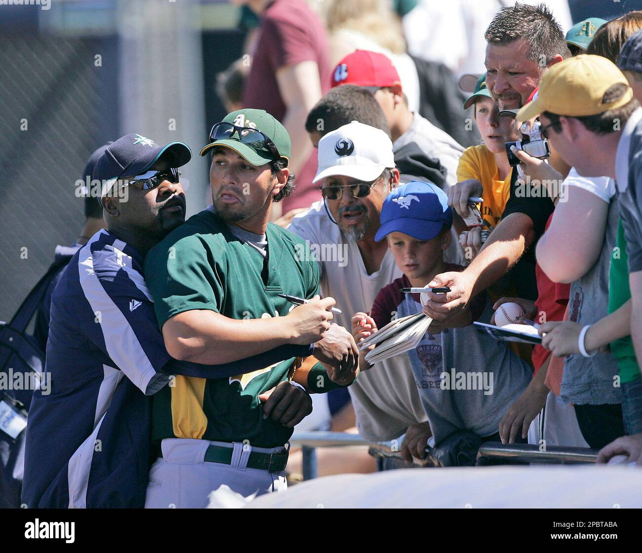 Oakland Athletics' Eric Chavez gets a hug from Seattle Mariners' Arthur ...