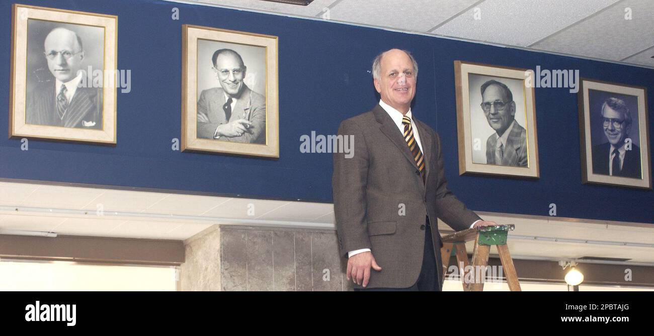 Alan Hirschfeld stands near photos that recall the generations of ...