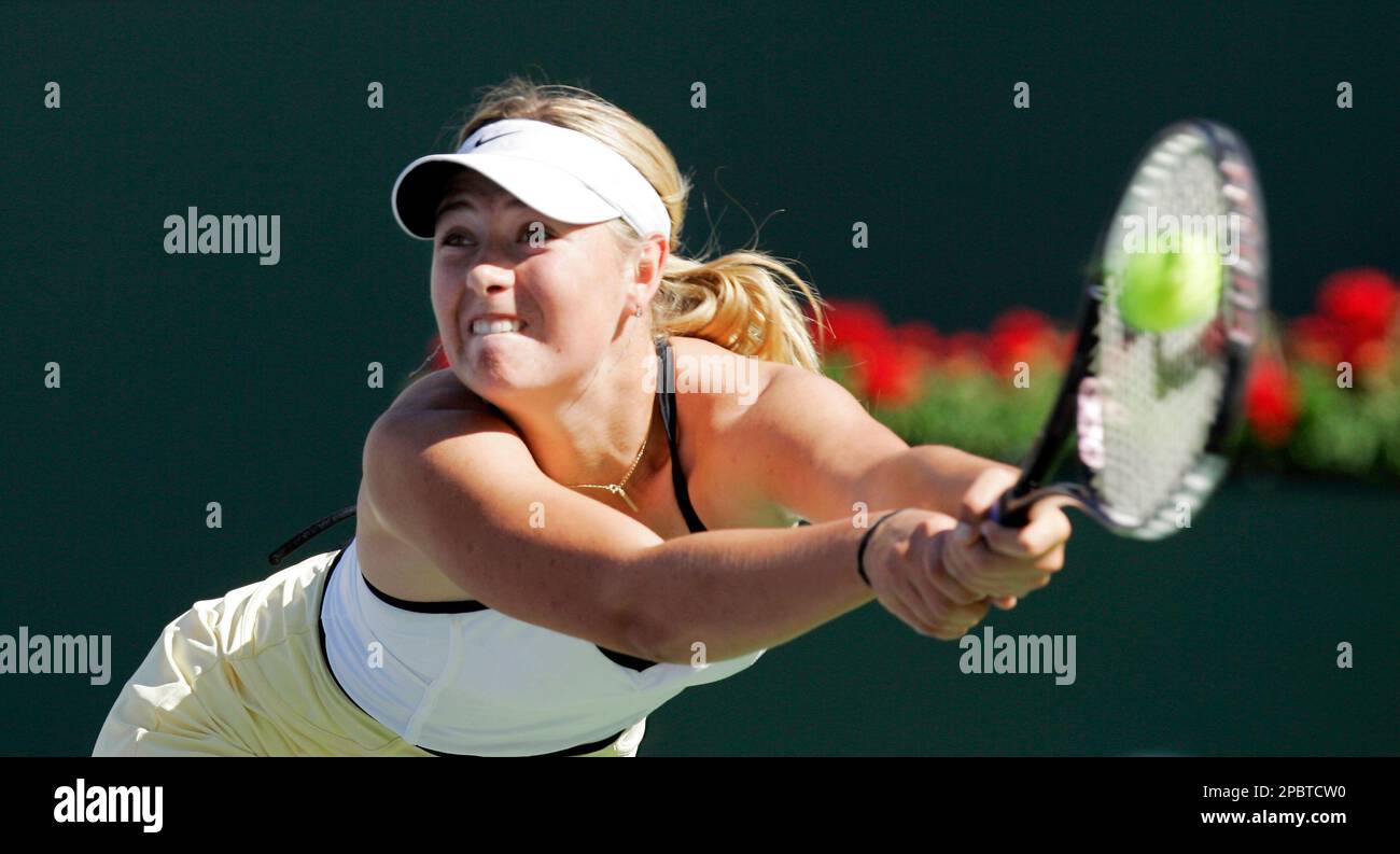 Maria Sharapova, of Russia, returns a shot to Nathalie Dechy, of France ...