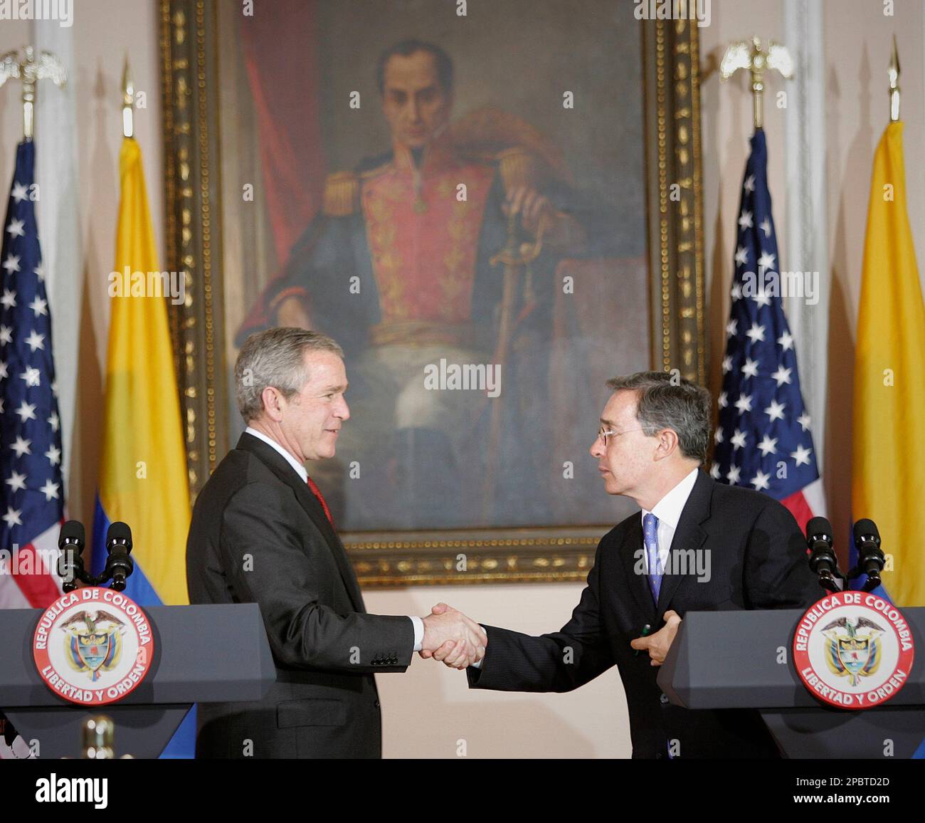 U.S. President George W. Bush, left, shakes hands with Colombia's ...
