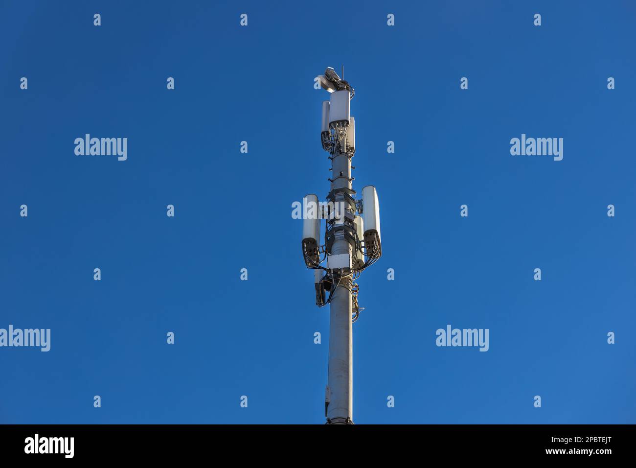 Close up of antenna repeater tower on blue sky Stock Photo - Alamy