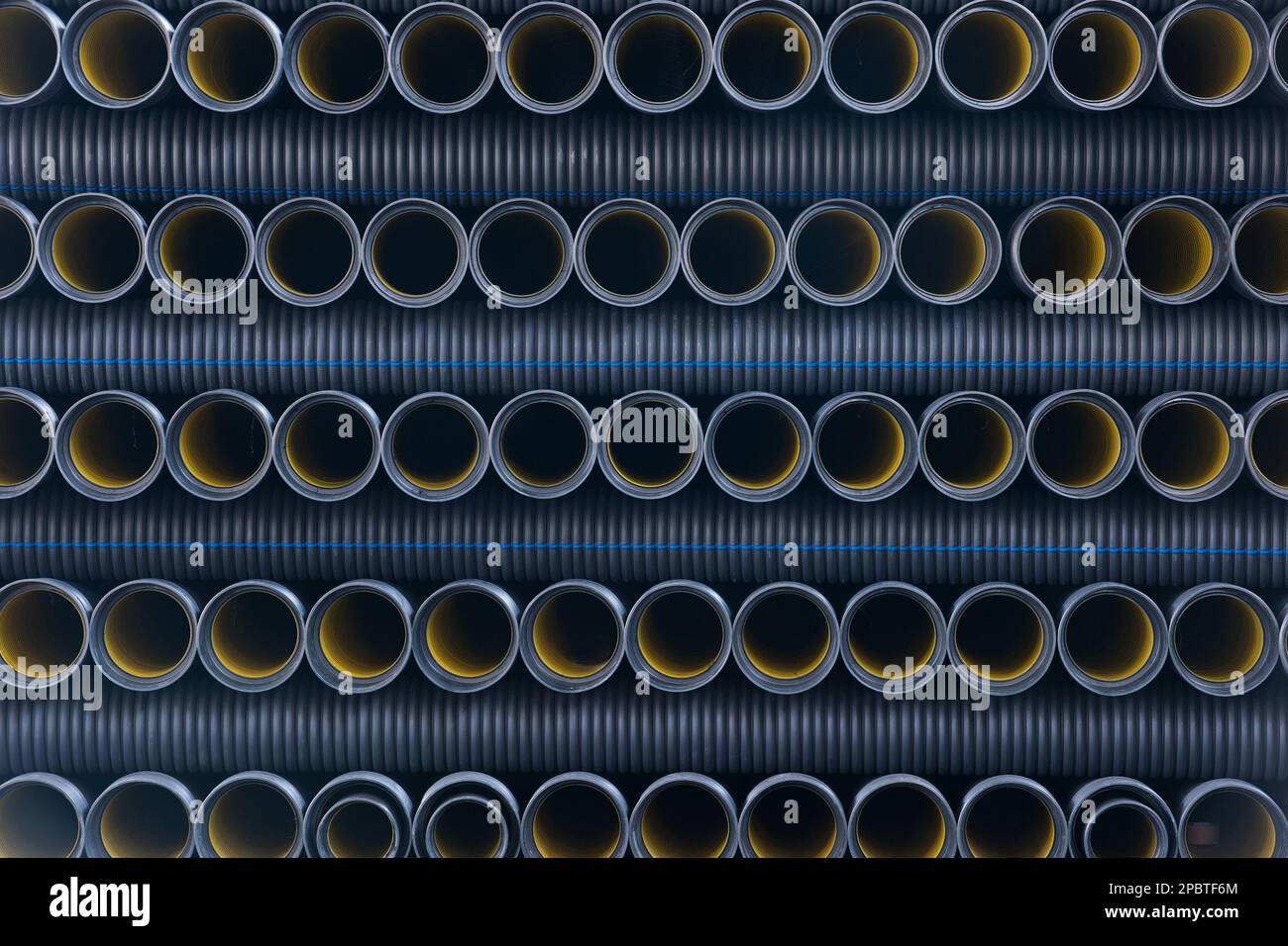 Bunches of PVC pipe sitting on palets at a wholesale pipe store Stock ...