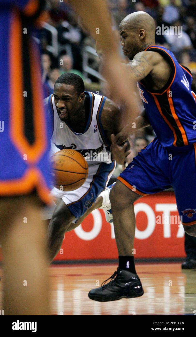 Washington Wizards' Gilbert Arenas, left, tries to navigate through the ...