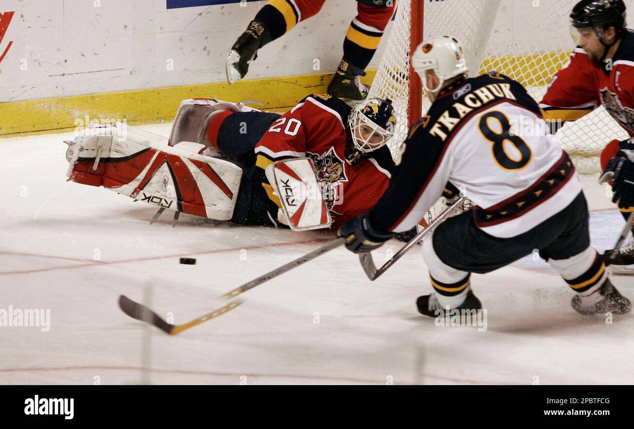 Florida Panthers goalie Ed Belfour (20) tries to keep the puck away ...