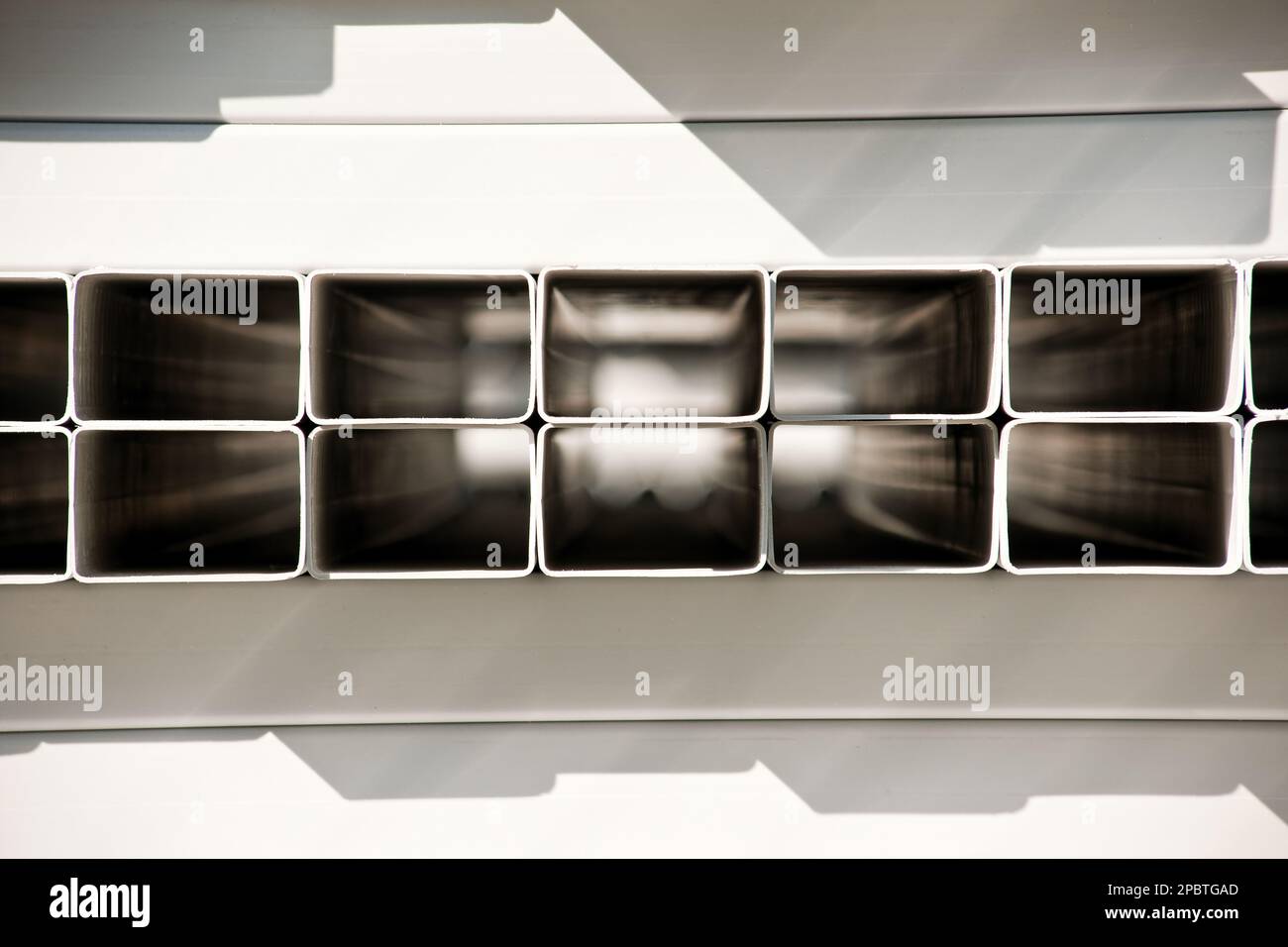 Bunches of PVC pipe sitting on palets at a wholesale pipe store Stock ...