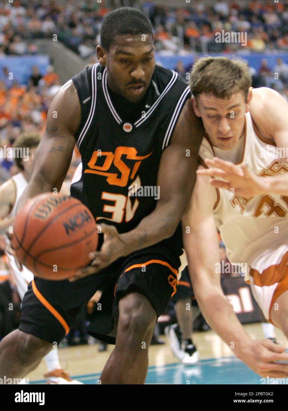 Oklahoma State forward David Monds (32) grabs a rebound as Texas ...