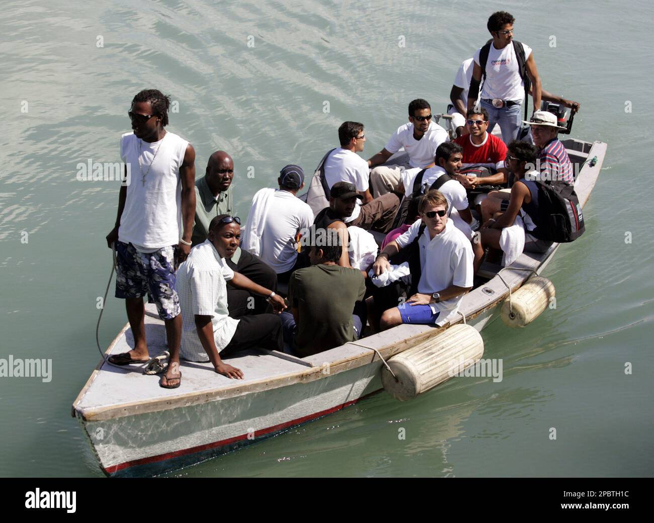 Members of the Indian cricket team travel on a motor boat during their ...
