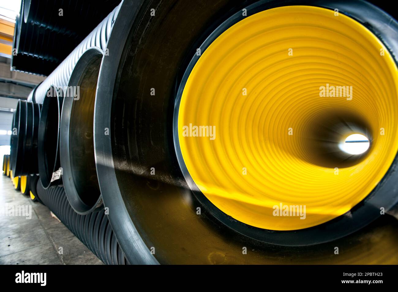 Bunches of PVC pipe sitting on palets at a wholesale pipe store Stock ...