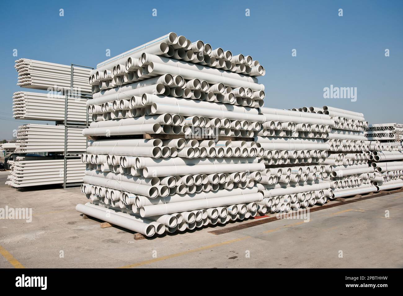 Bunches of PVC pipe sitting on palets at a wholesale pipe store Stock ...