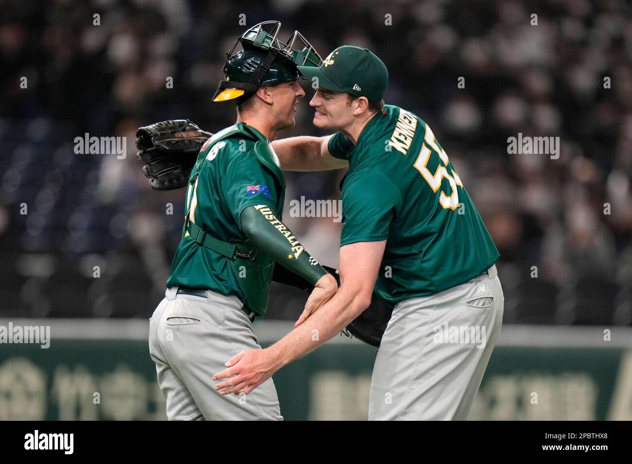 Australia's pitcher Jon Kennedy, right, and catcher Robert Perkins hug ...