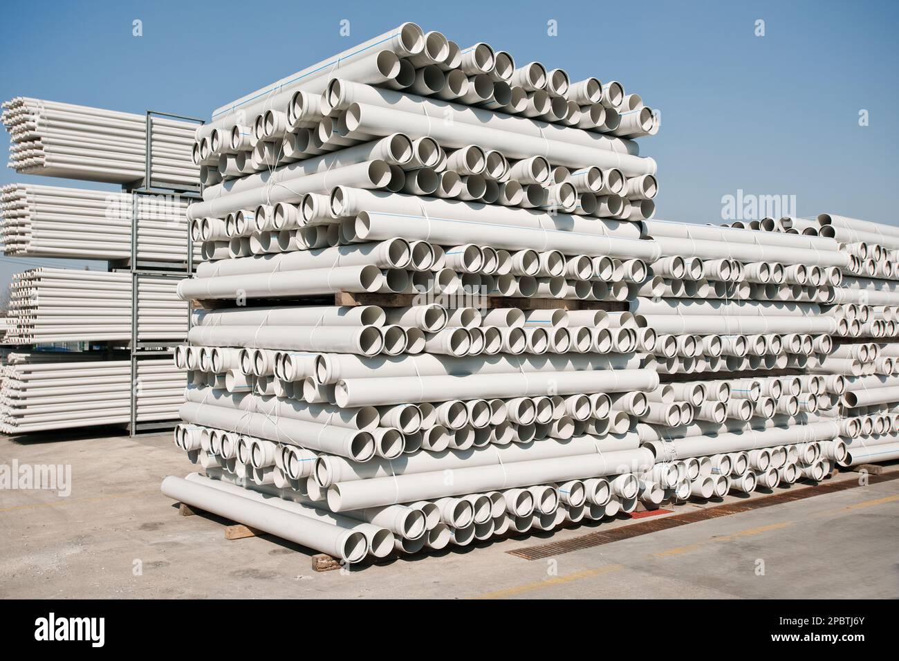 Bunches of PVC pipe sitting on palets at a wholesale pipe store Stock ...