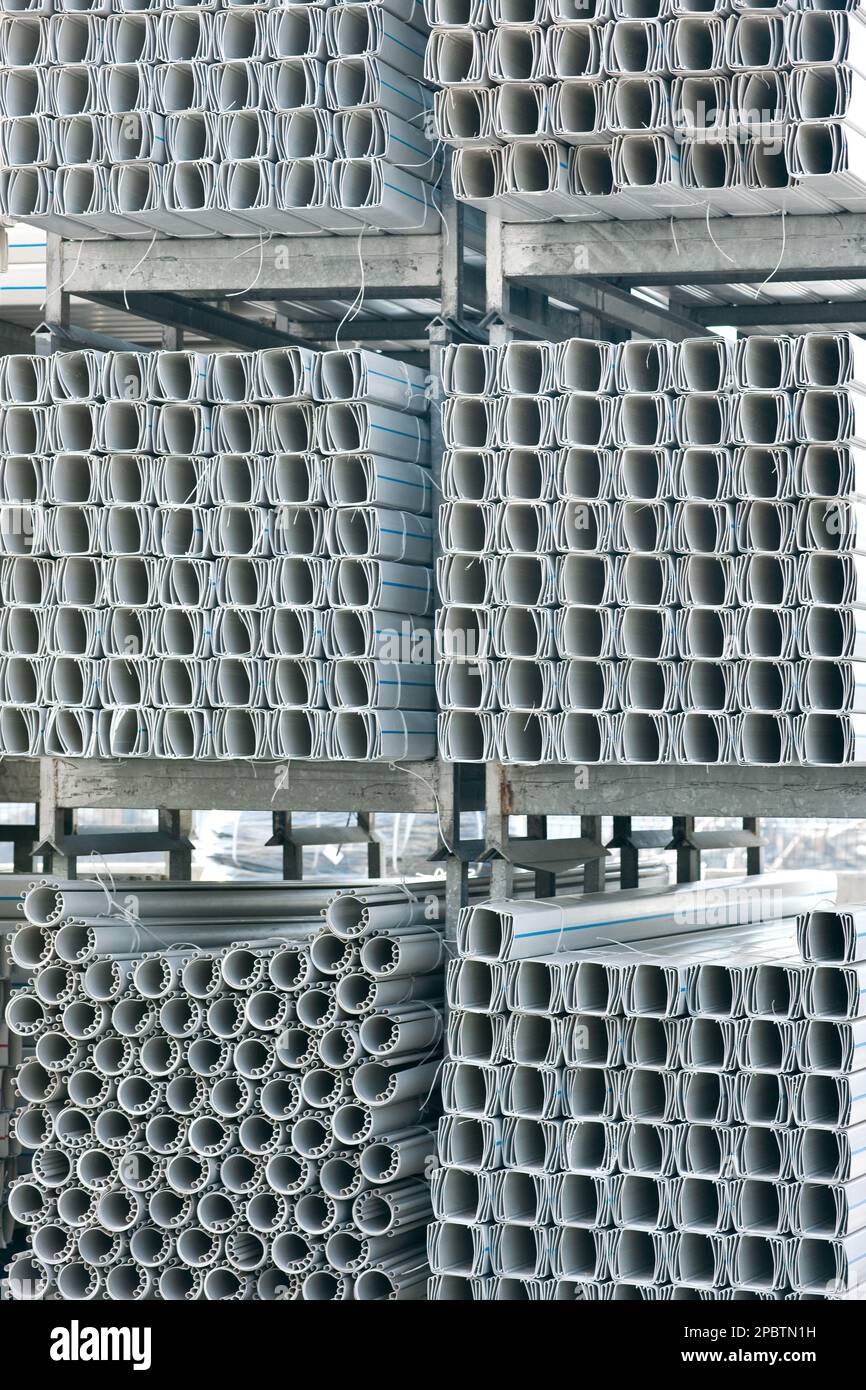 Bunches of PVC pipe sitting on palets at a wholesale pipe store Stock ...