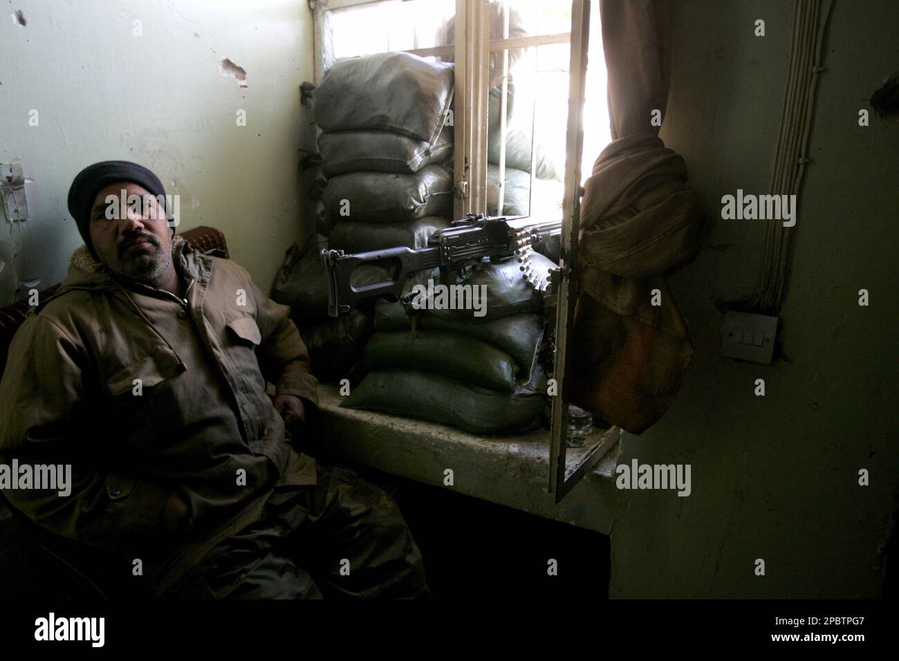 An Iraqi soldier mans a machine gun position at their outpost in ...