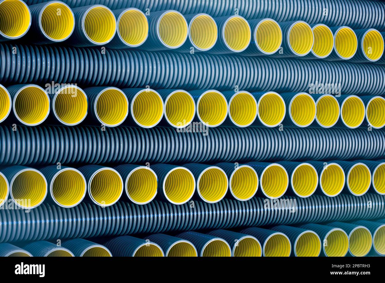 Bunches of PVC pipe sitting on palets at a wholesale pipe store Stock ...