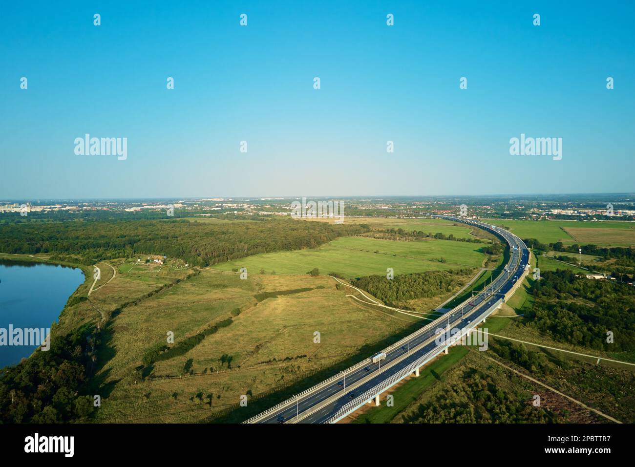 Cars driving on highway near green fields, top view. Aerial drone view ...