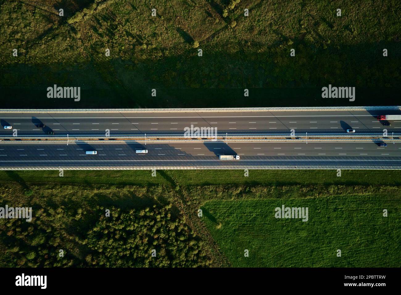 Cars driving on highway near forest trees, top view. Aerial drone view ...
