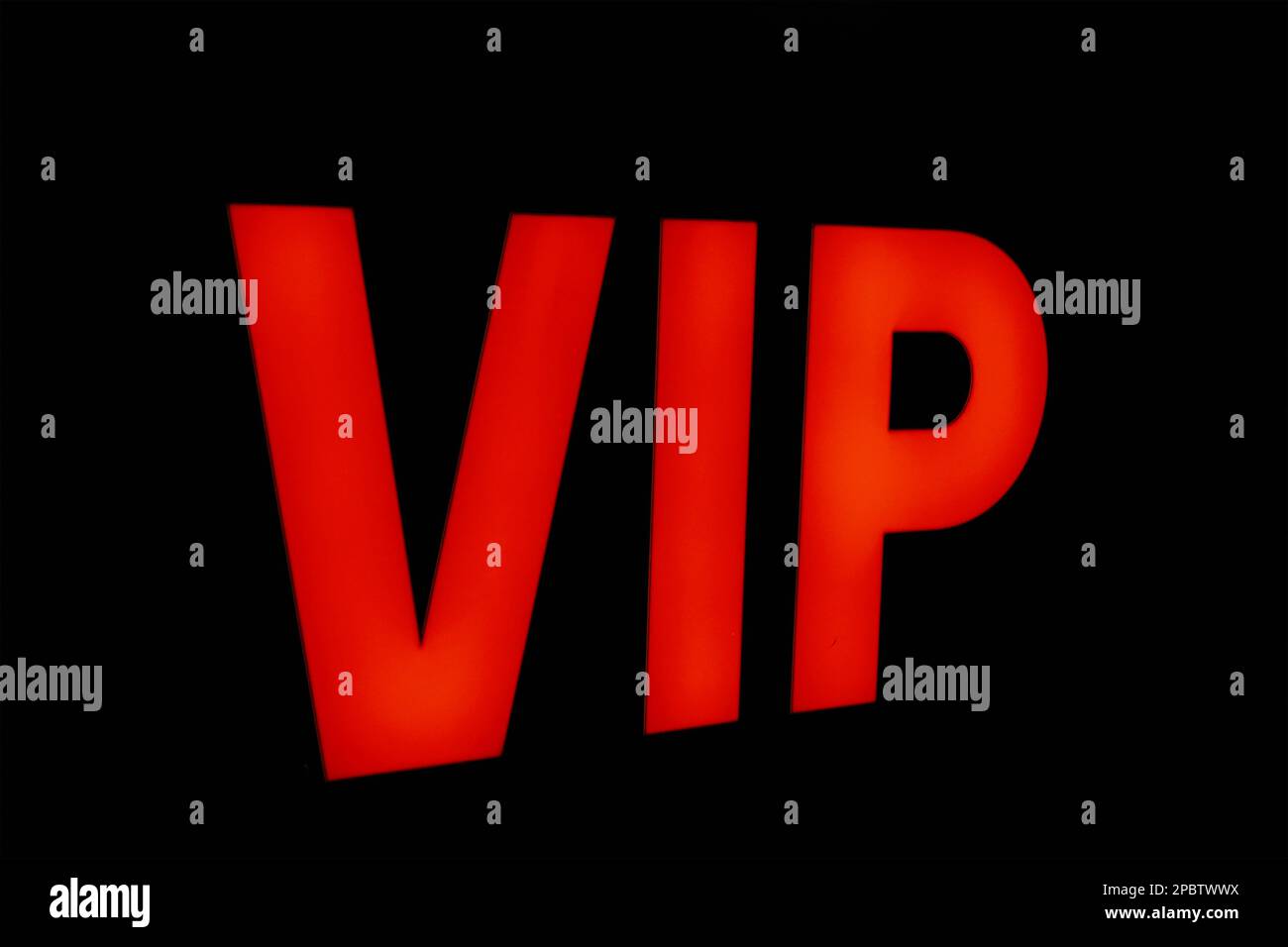 Inscription VIP, red letters on dark background Stock Photo - Alamy