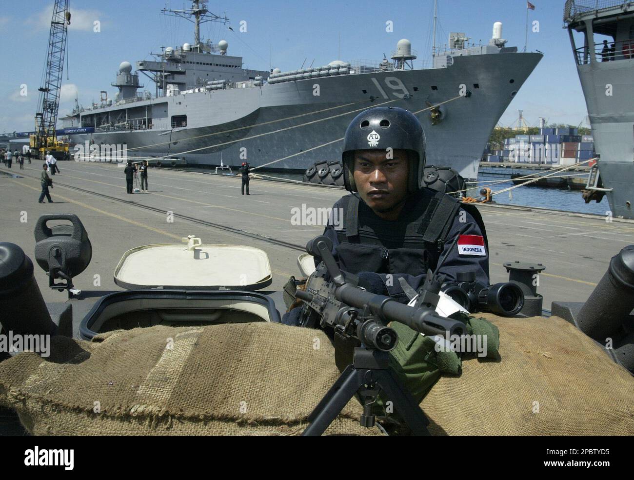 A member of Indonesian Navy Frogman Commandos mans a machine gun on an ...