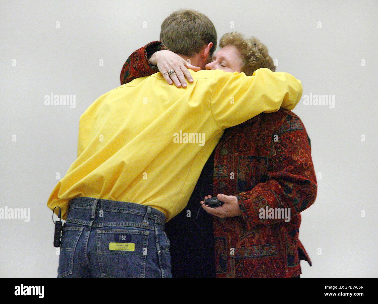 Clint Haskins, left, and Deborah McLeland hug during a discussion in ...