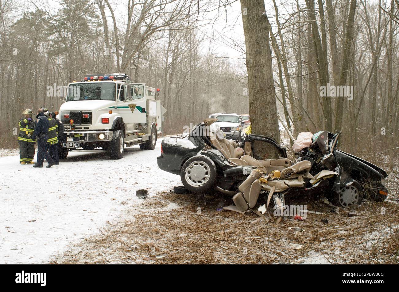 Emergency workers confer at the scene of a double fatal accident on ...