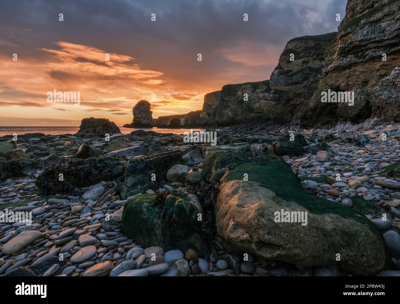 Dramatic low angle dawn seascape at Marsden Beach in North East England ...
