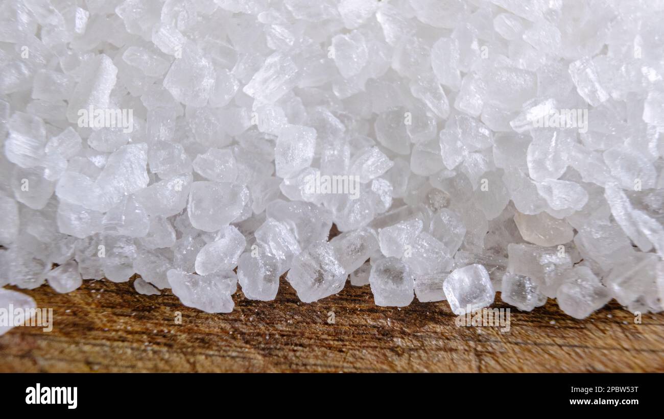 Lots of sea salt crystals for food use on a wooden background Stock ...