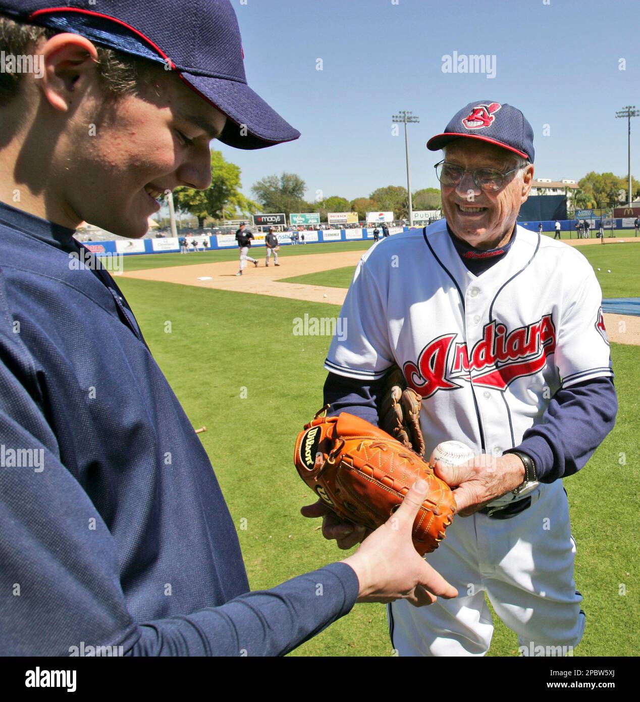 Major League Baseball Hall of Fame member Bob Feller, right, hands a ...